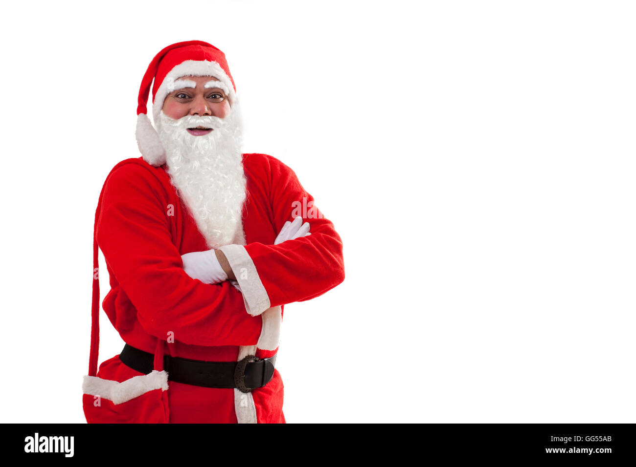 Front view of Santa Claus standing with arms crossed over white ...