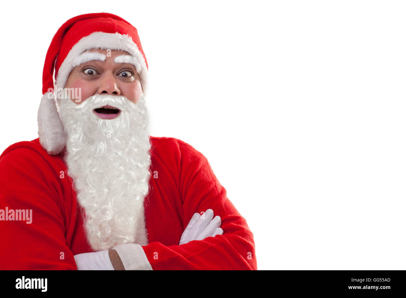 Close-up of surprised Santa Claus with arms folded over white ...