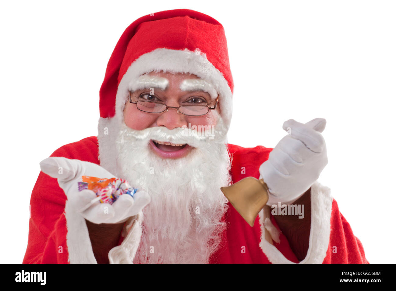 Close-up of happy Santa giving chocolates with bell in hand over white ...