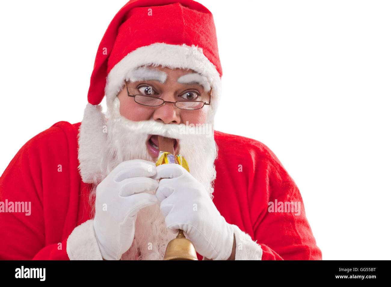 Close-up of Santa Claus eating chocolate bar over white background ...