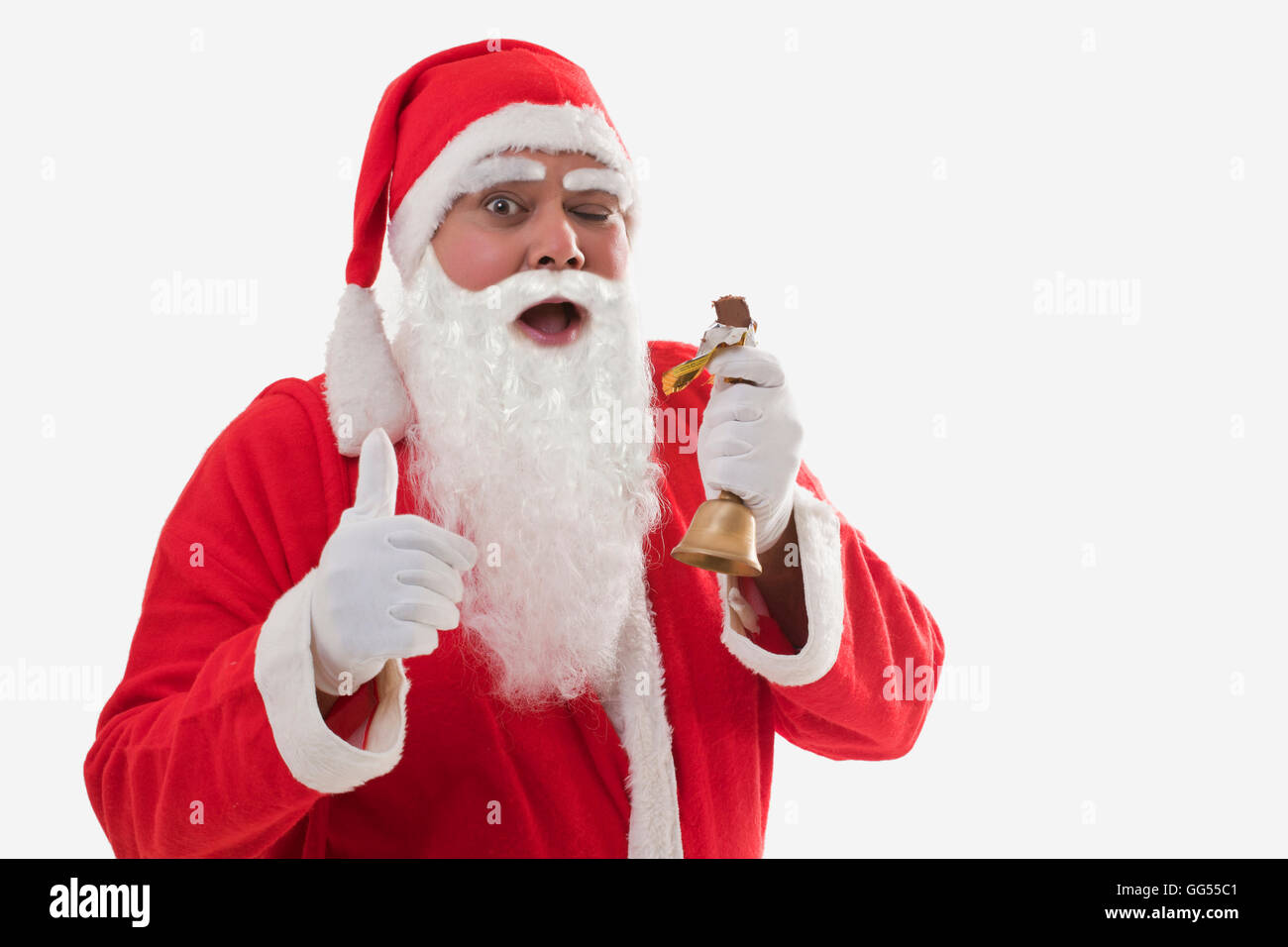 Front view of Santa Claus showing thumbs up while eating chocolate bar ...
