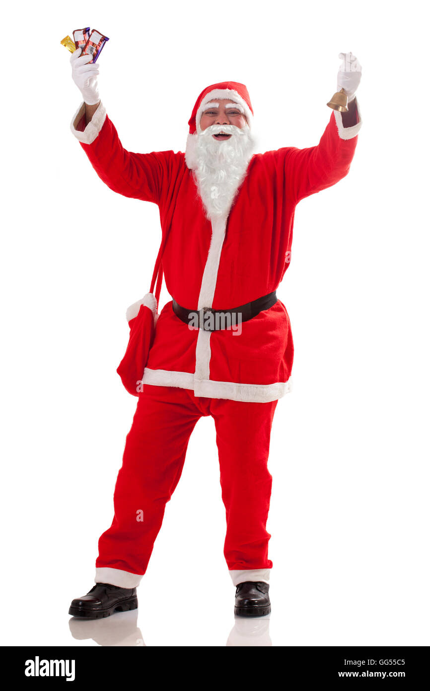Full length of cheerful Santa Claus with chocolates over white ...