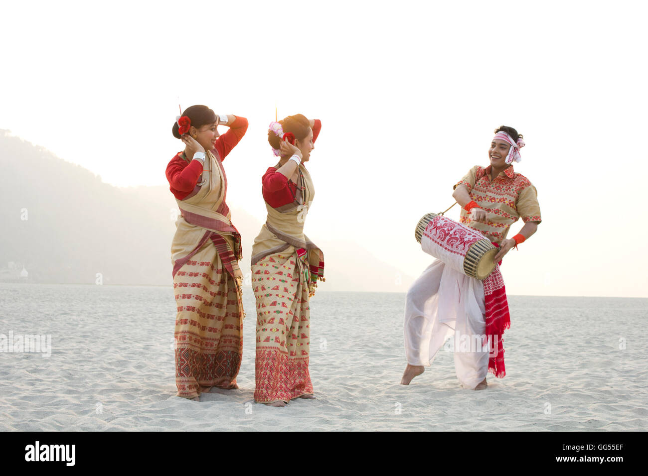 Bihu women dancing as Bihu man plays on a dhol Stock Photo - Alamy