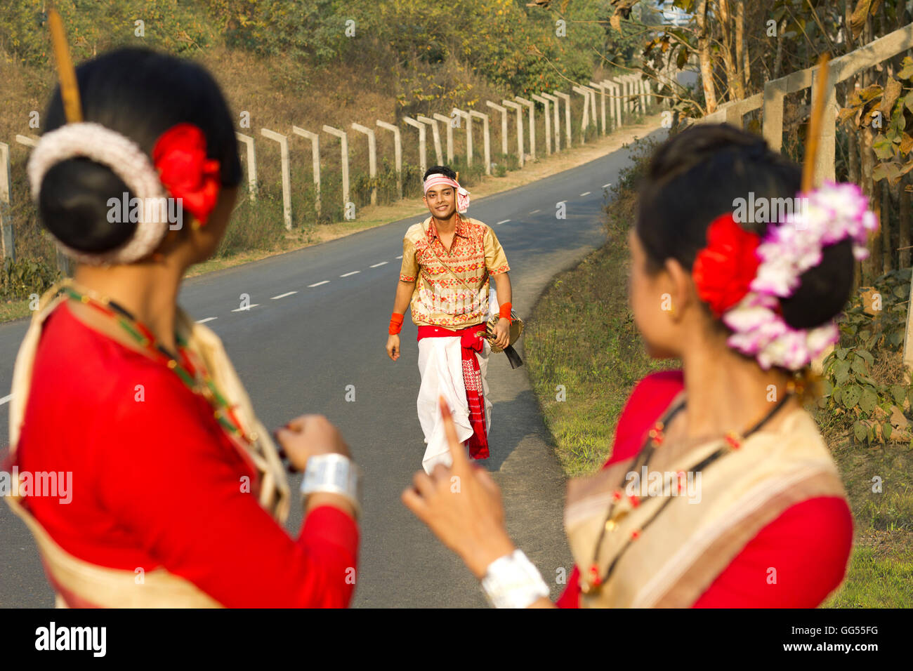 Bihu dancers look on as a Bihu man walks up to them Stock Photo - Alamy