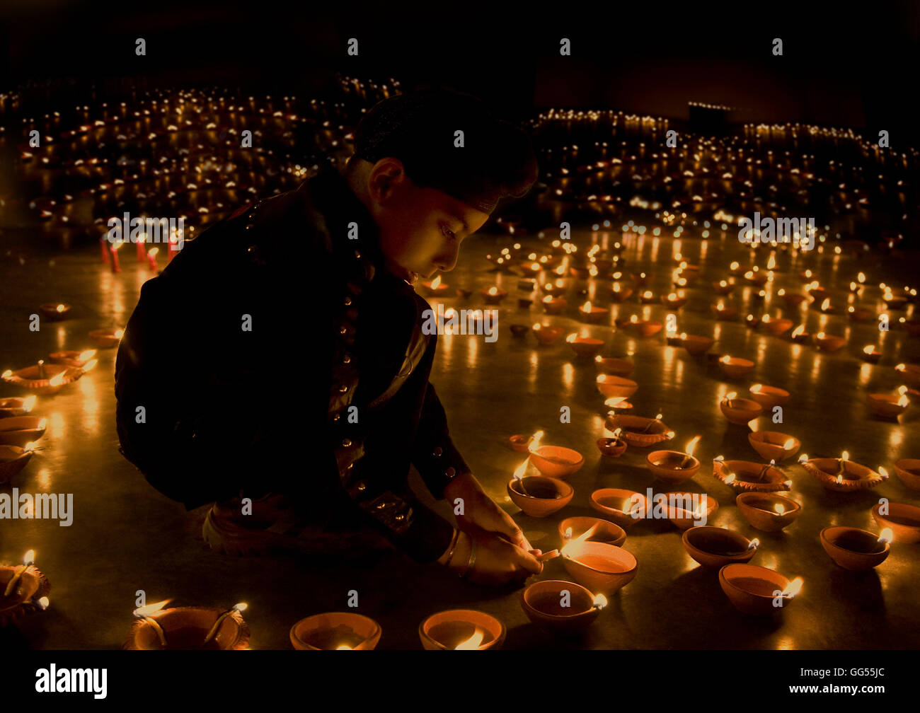 A boy lighting diyas Stock Photo - Alamy