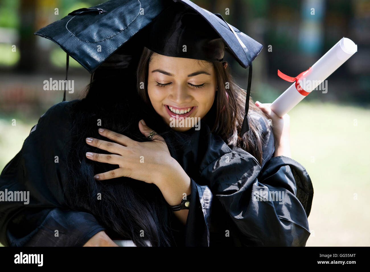 College graduates hugging Stock Photo - Alamy