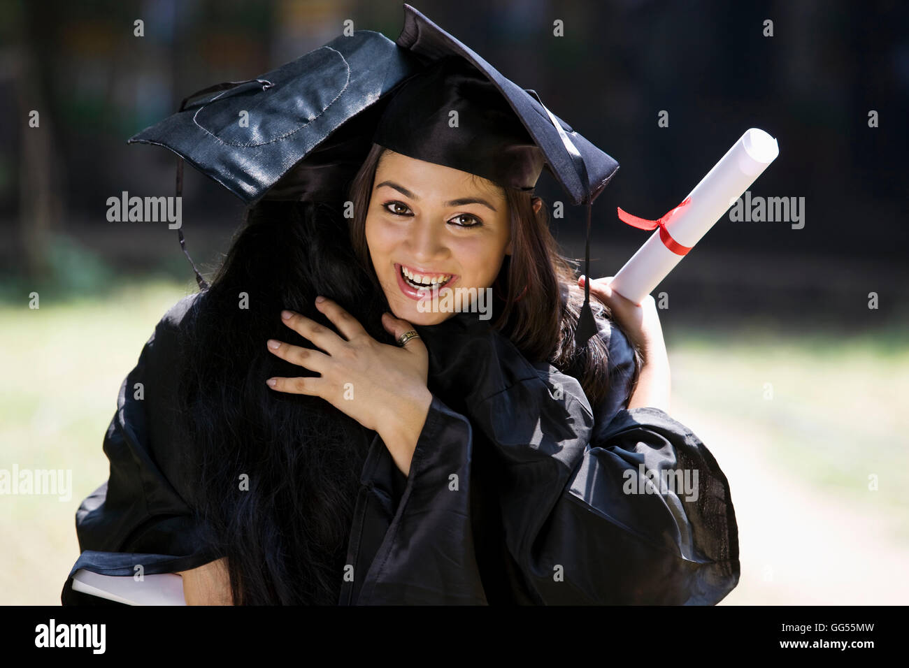 College graduates hugging Stock Photo - Alamy