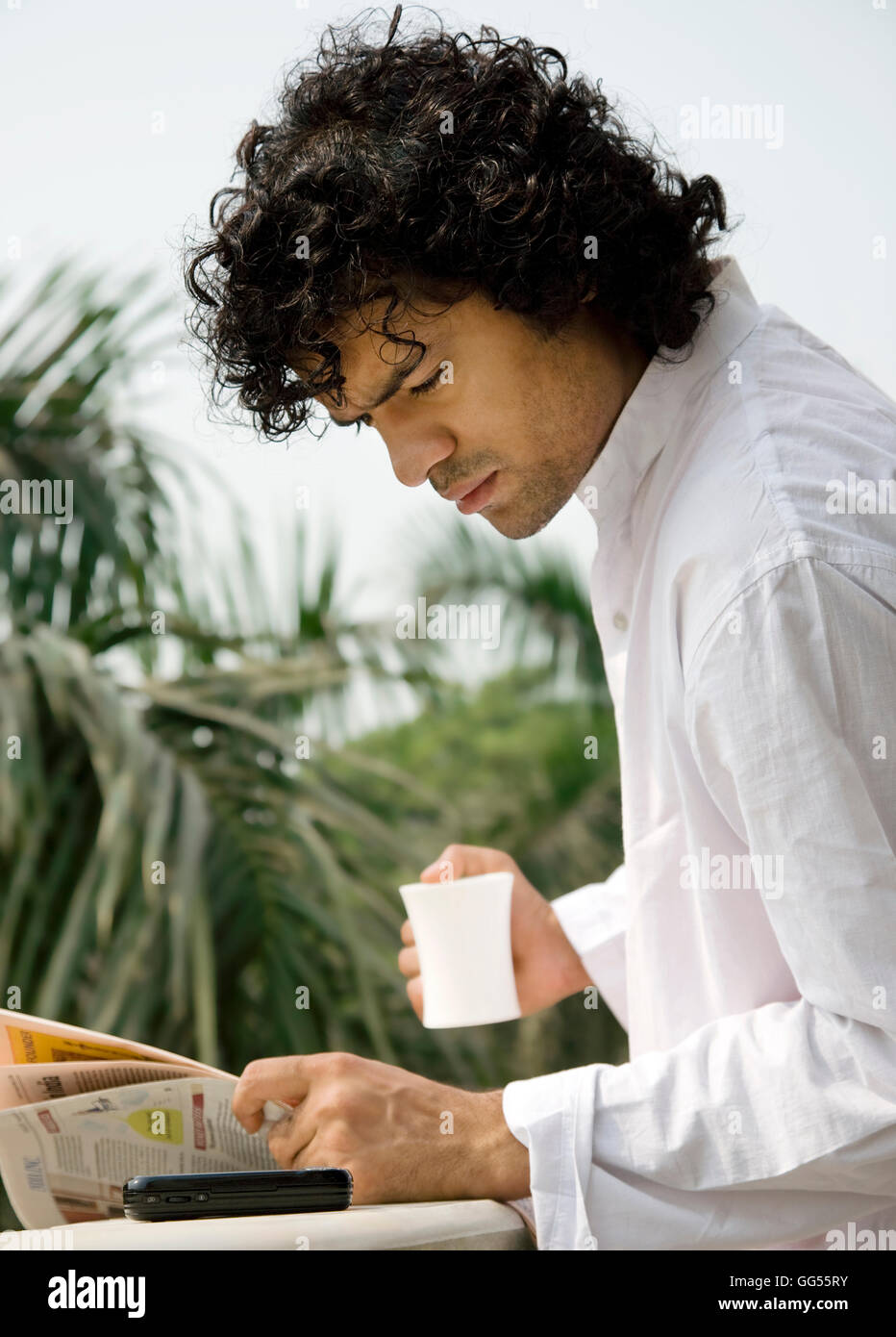 Man reading the newspaper Stock Photo - Alamy