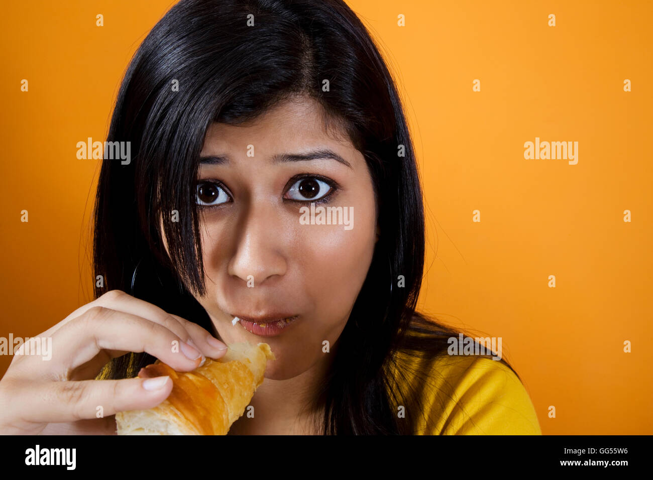 Woman eating a patty Stock Photo - Alamy