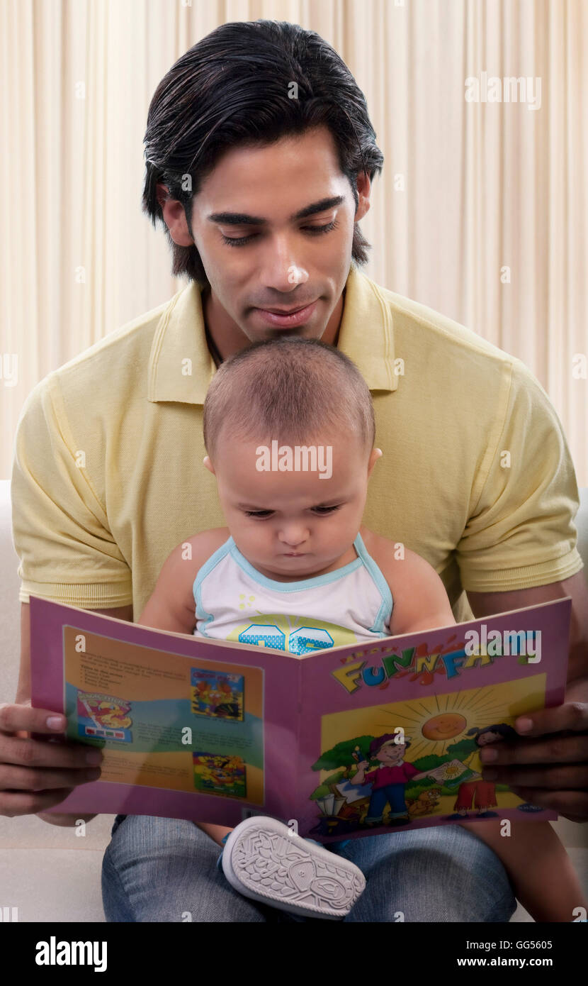 Father and son reading a book Stock Photo - Alamy