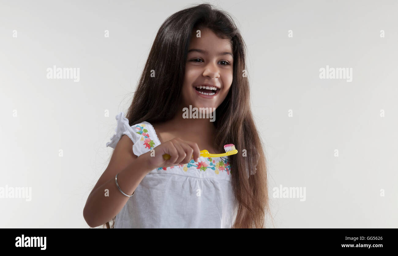 Girl with toothbrush and toothpaste Stock Photo - Alamy