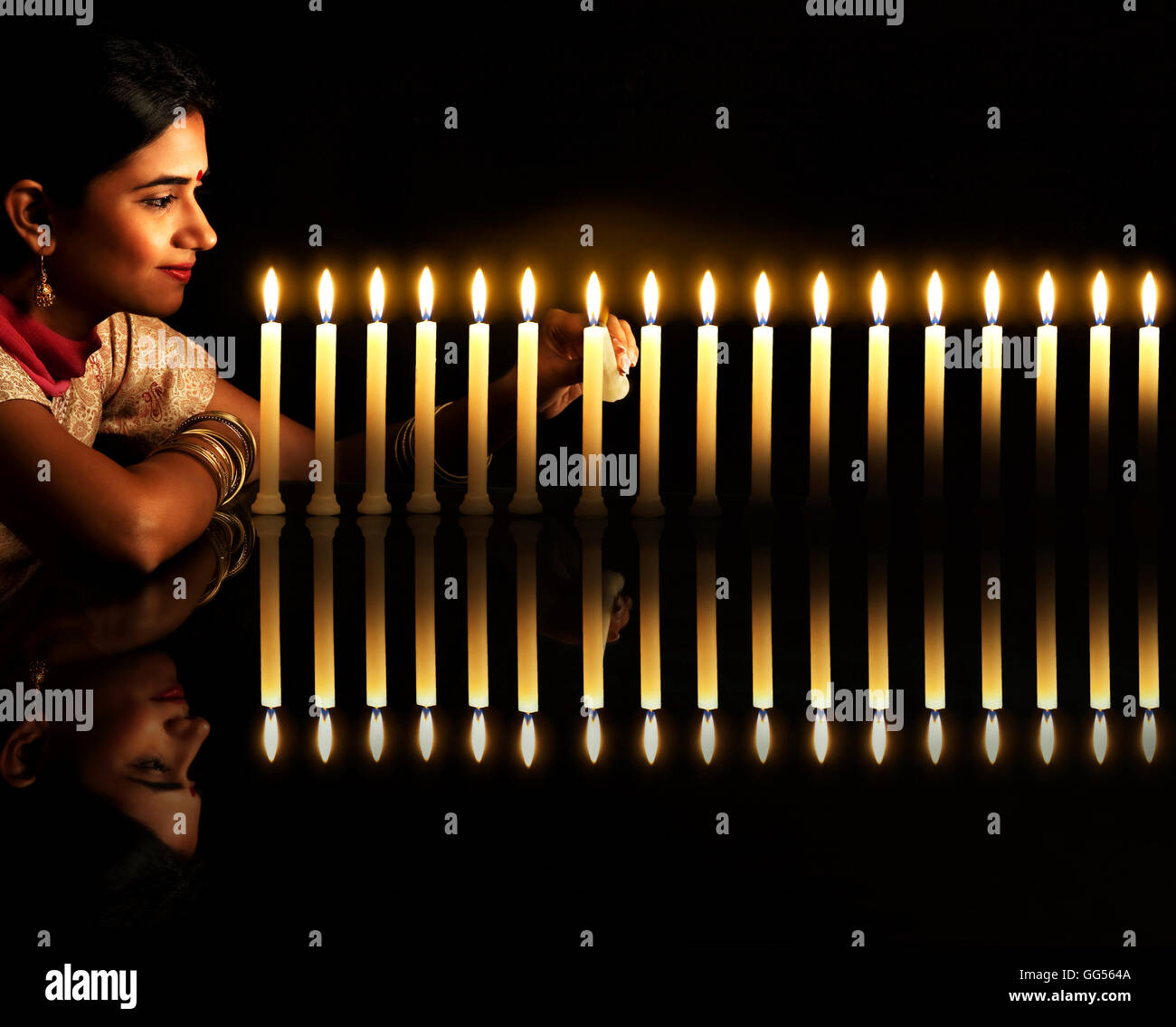 Woman lighting candles Stock Photo - Alamy
