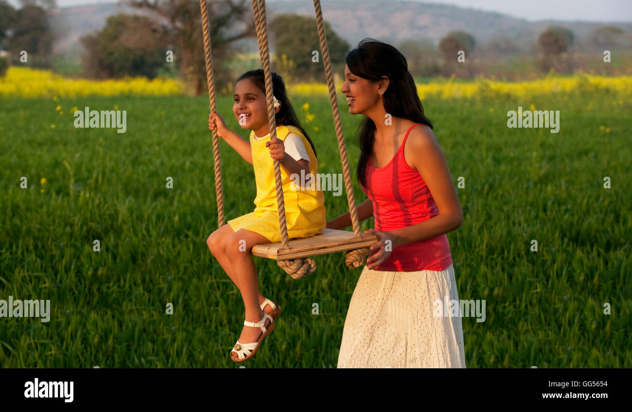 Kids Swinging With Parents High Resolution Stock Photography and Images - Alamy