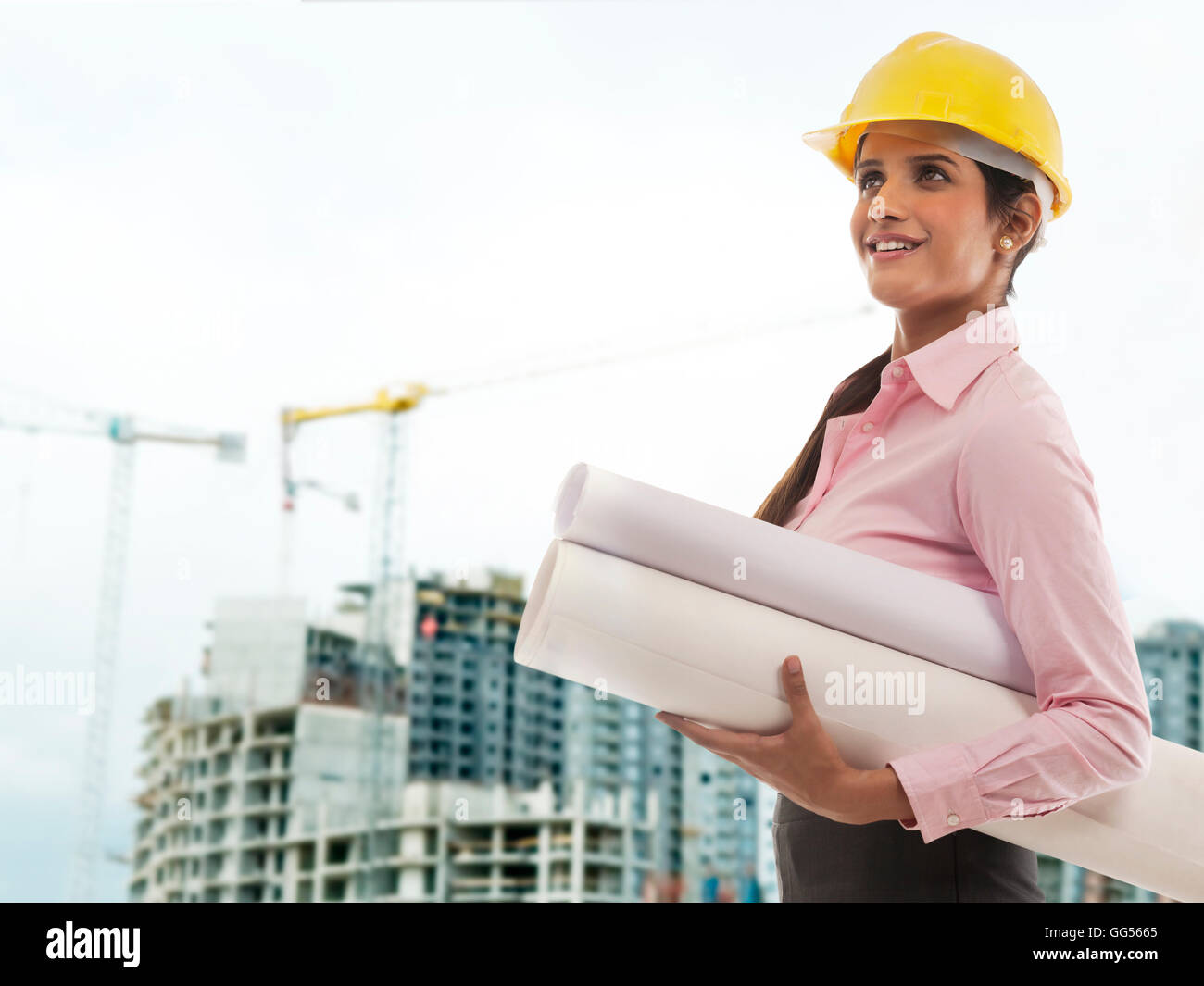 Female engineer with blueprints Stock Photo - Alamy