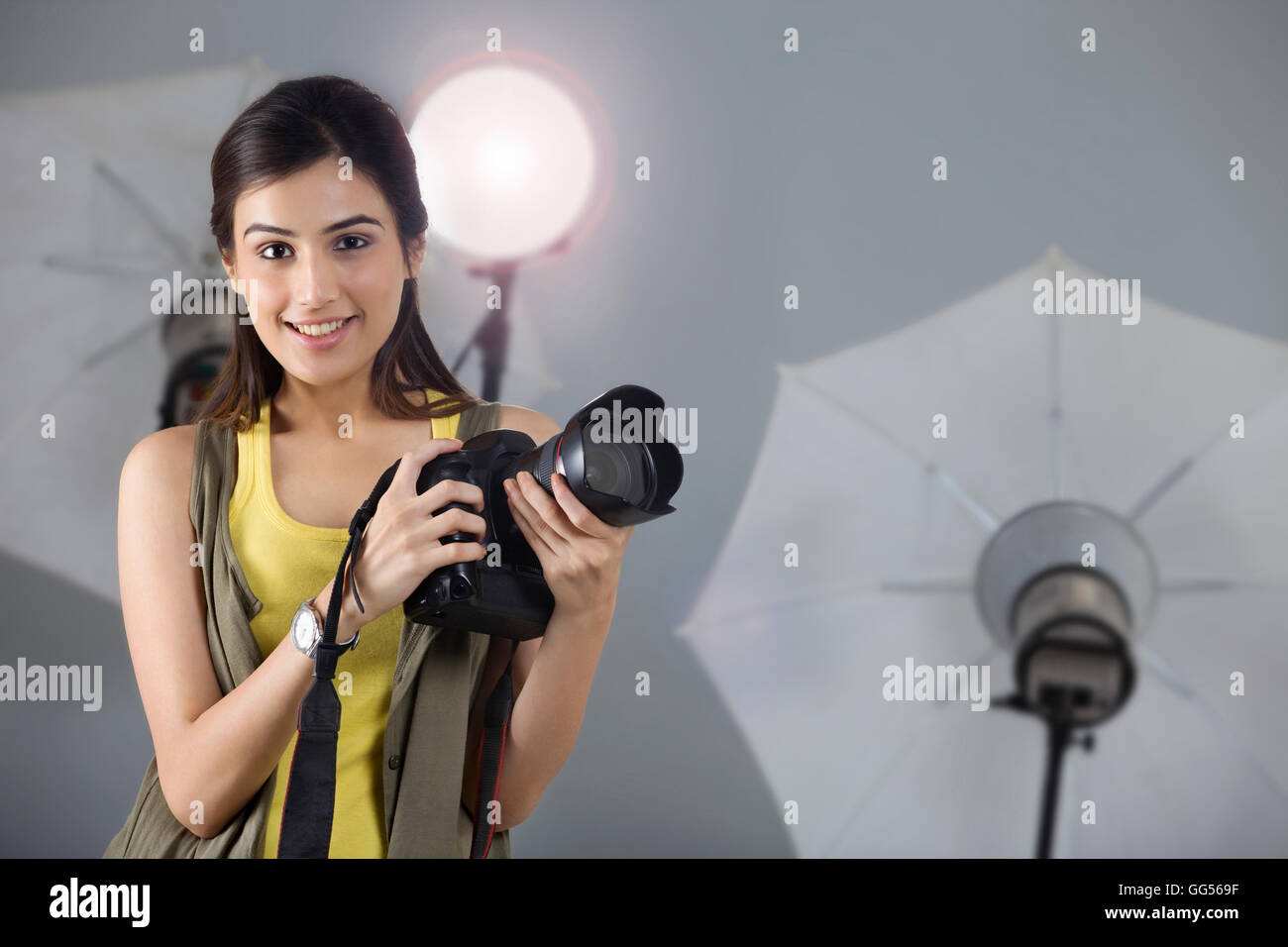 Portrait of beautiful photographer smiling with digital camera in ...