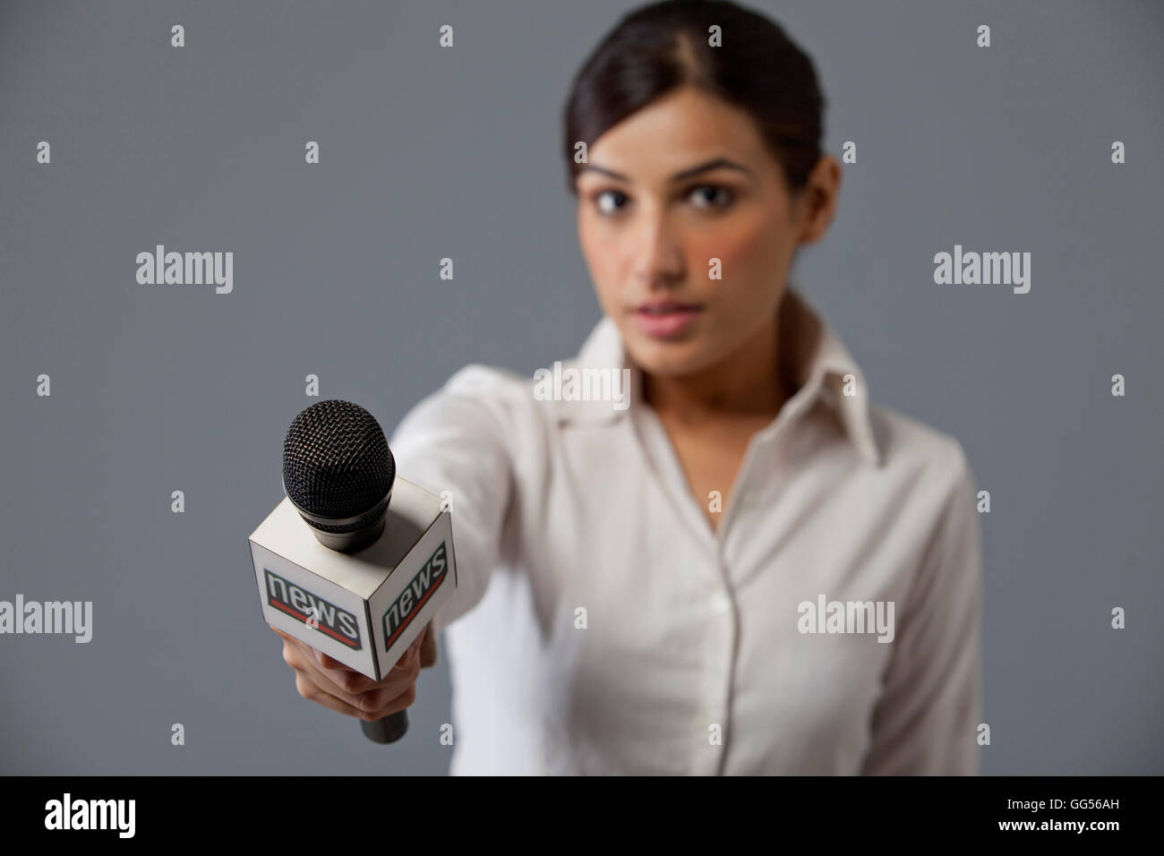 Close-up of young woman news reporter holding out microphone Stock ...
