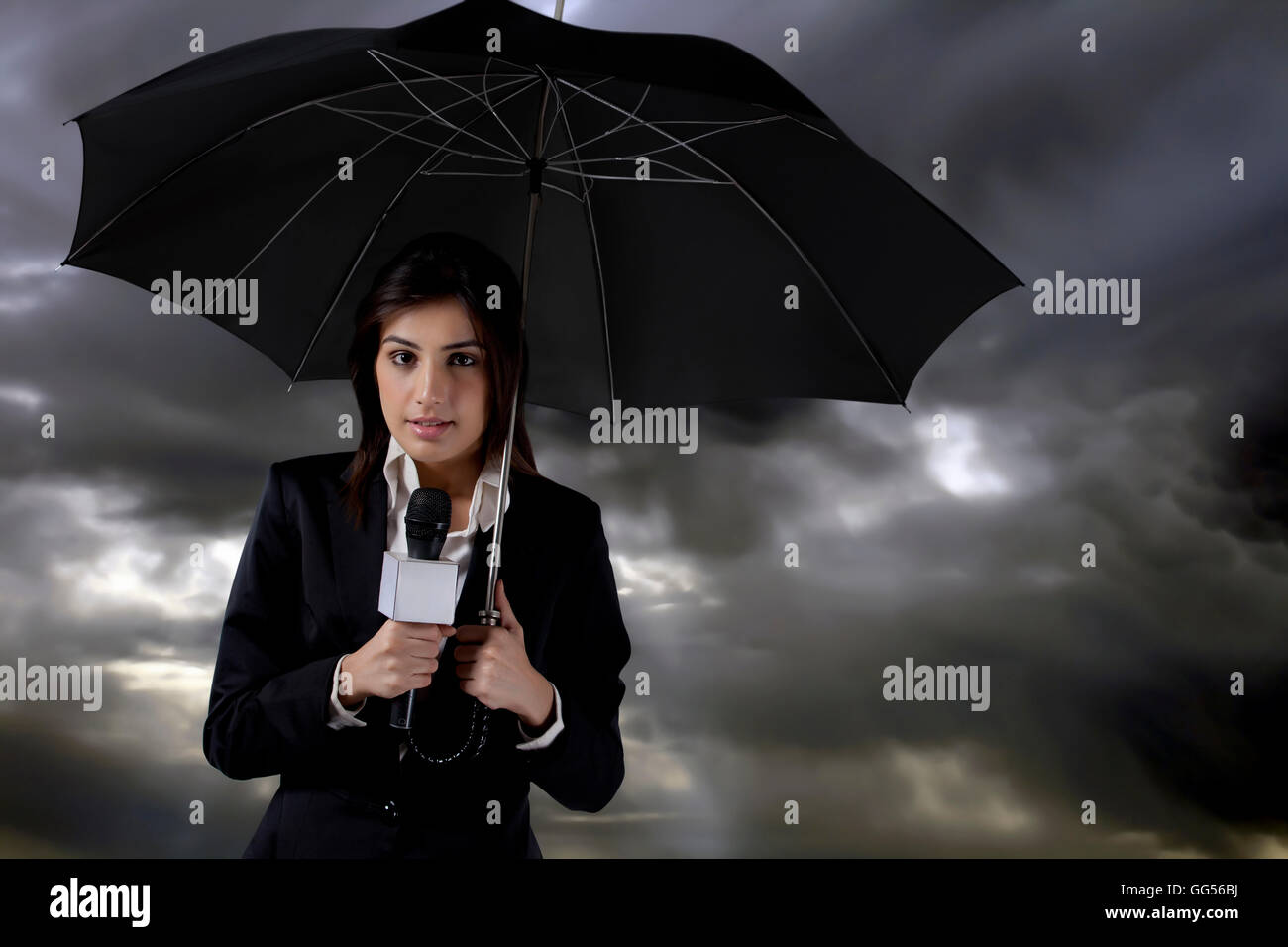 Female reporter standing in rain Stock Photo - Alamy