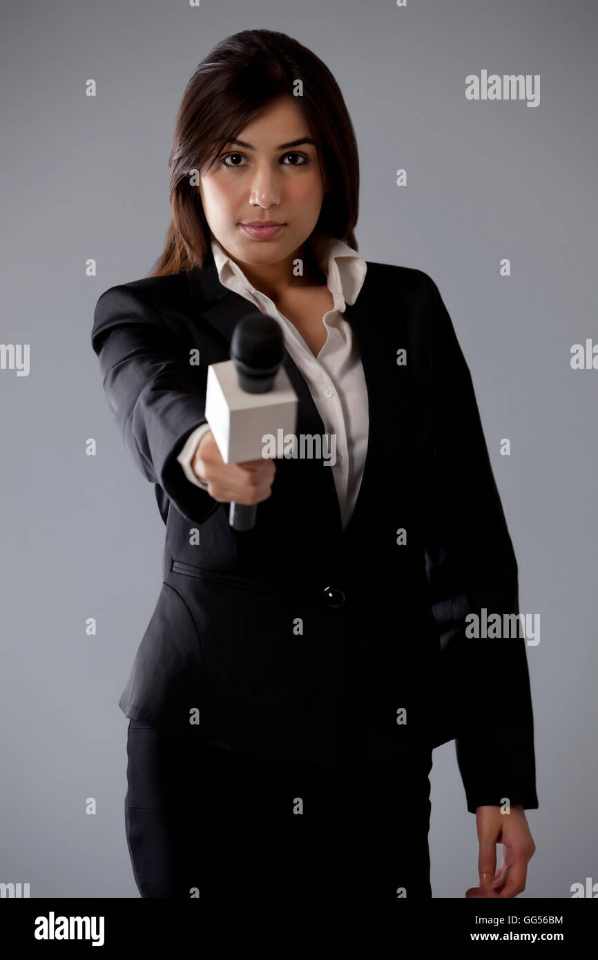 Portrait of beautiful young reporter asking comment Stock Photo - Alamy