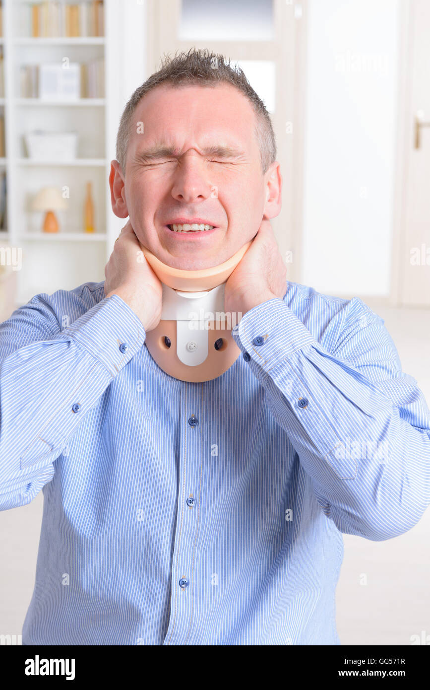 Man with a surgical cervical collar suffering from neck pain Stock ...