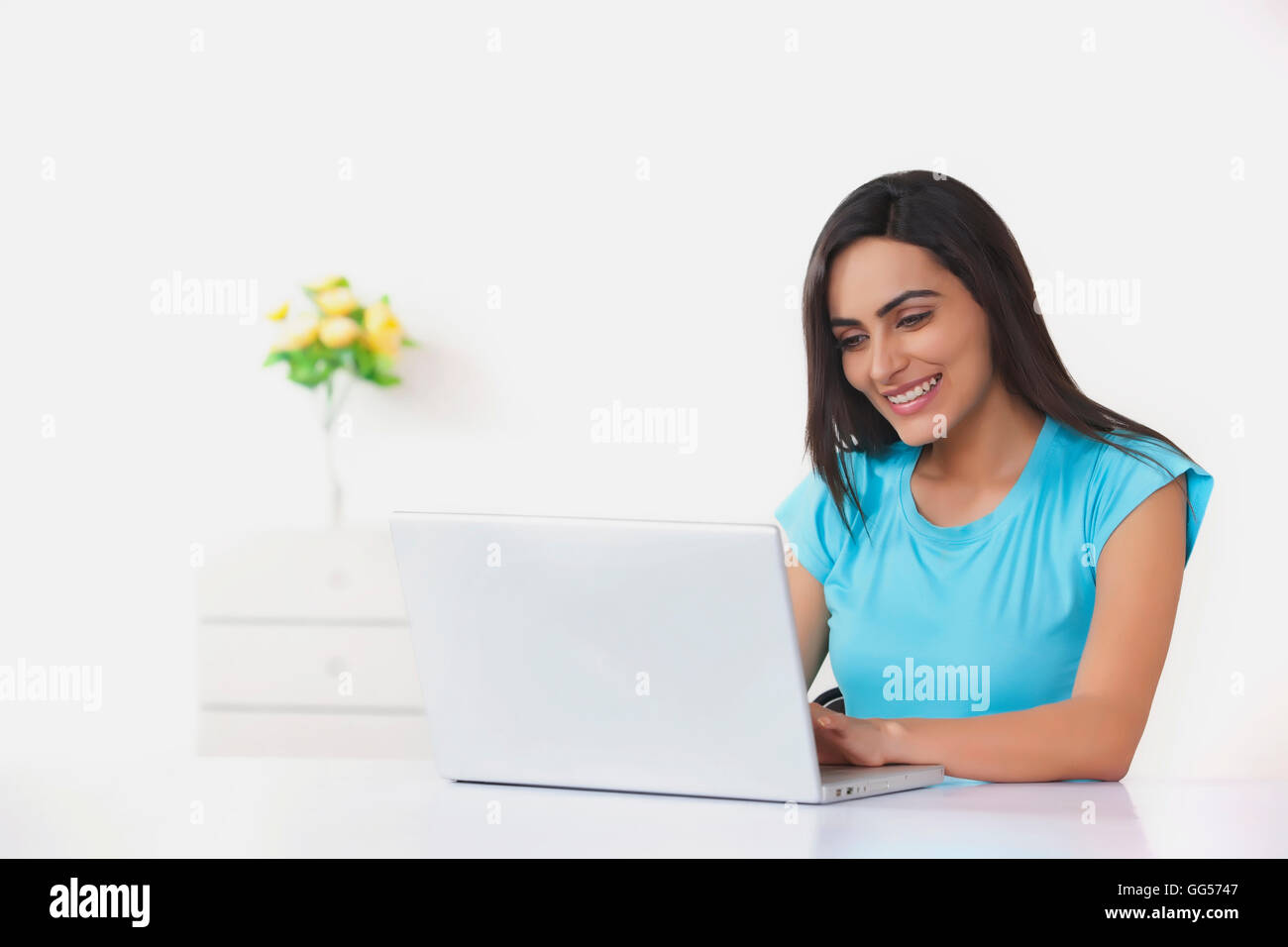 Happy indian using laptop hi-res stock photography and images - Alamy