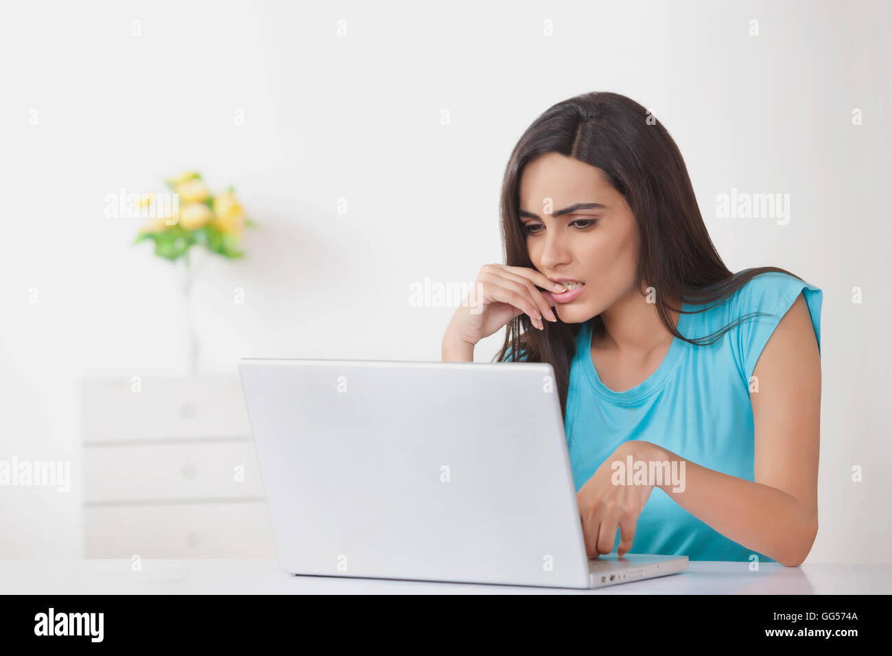 Young woman using laptop at home Stock Photo - Alamy