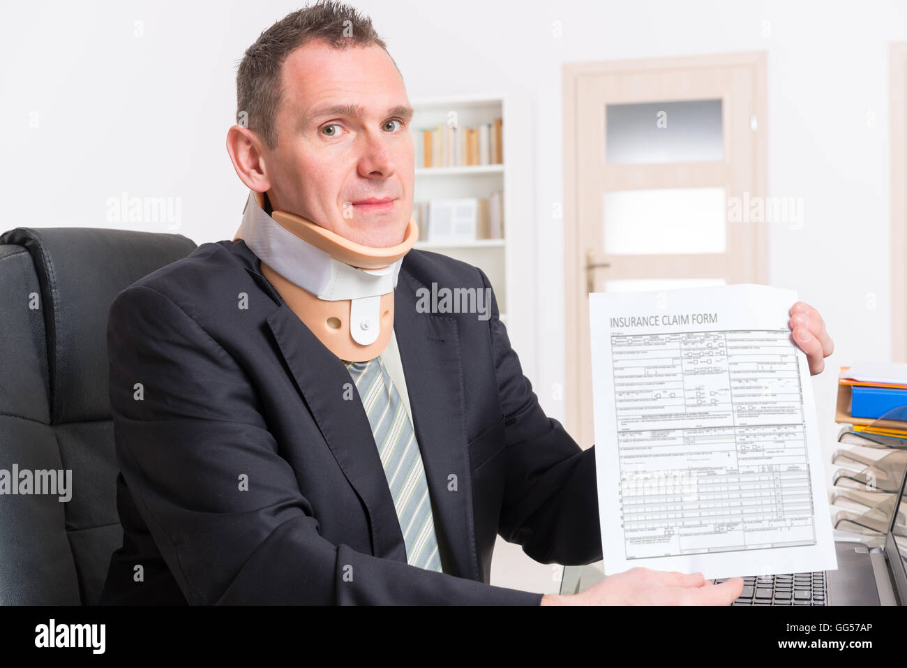 Businessman at work wearing neck brace with insirance flaim form in ...