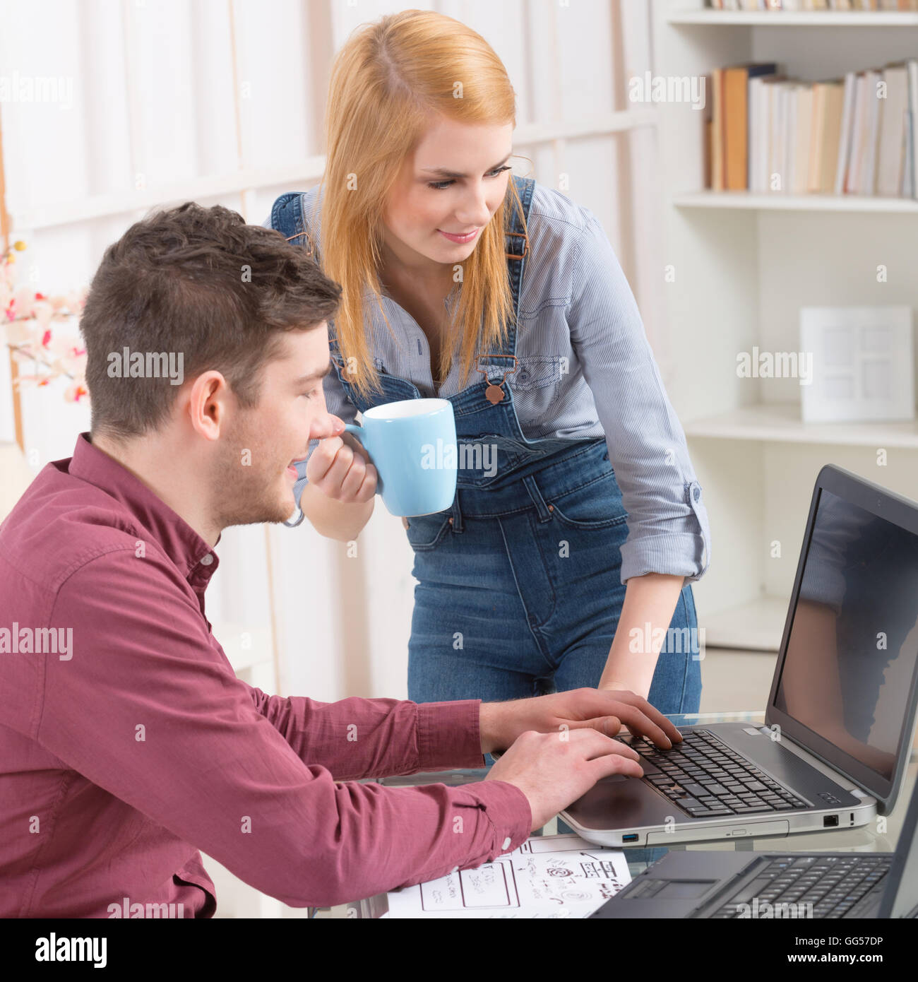 Happy couple looking at laptop computer screen Stock Photo - Alamy