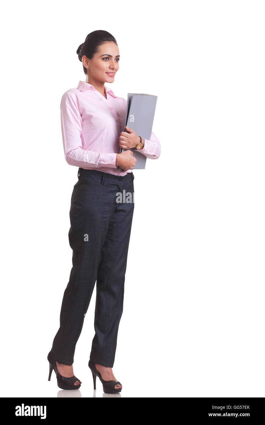 Full length of Indian businesswoman holding file folder over white ...
