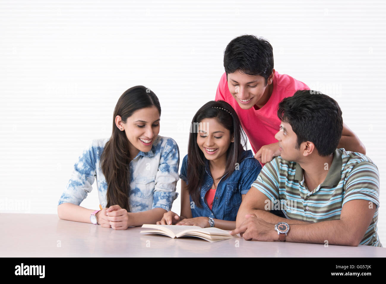 Young college students studying in library Stock Photo - Alamy