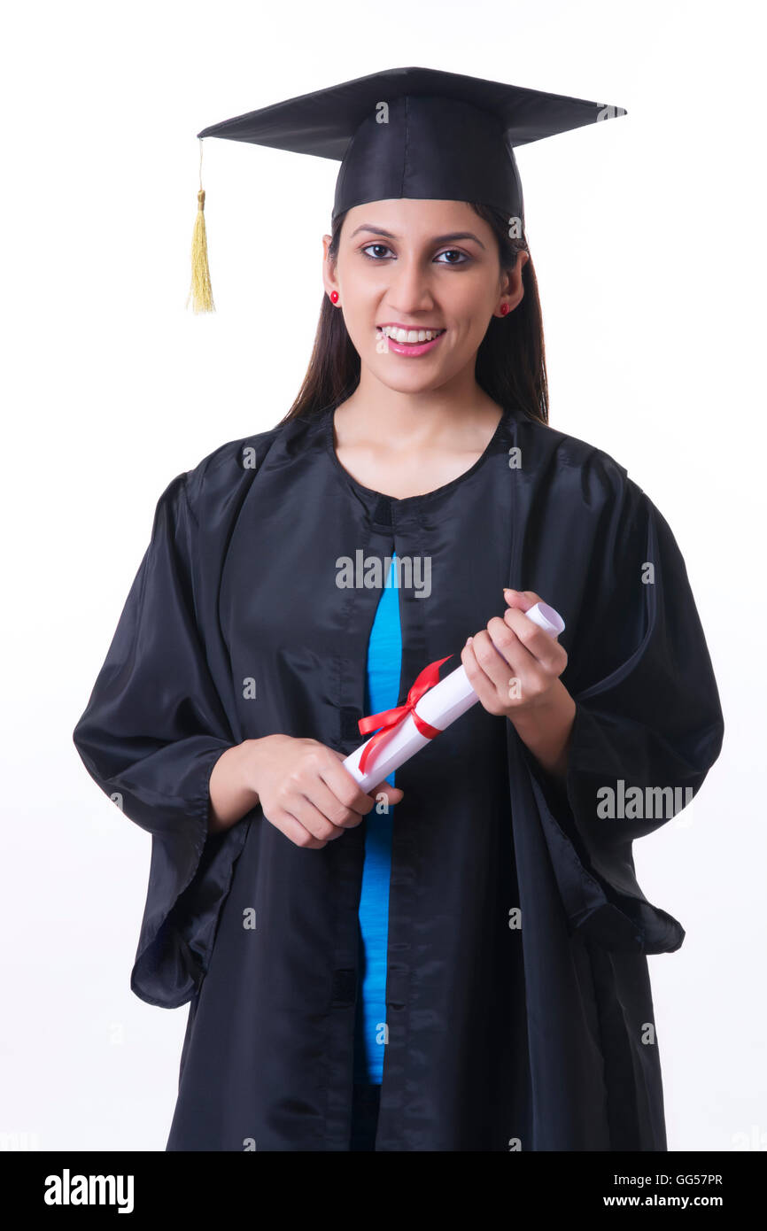 Portrait of confident graduate student holding diploma against white ...