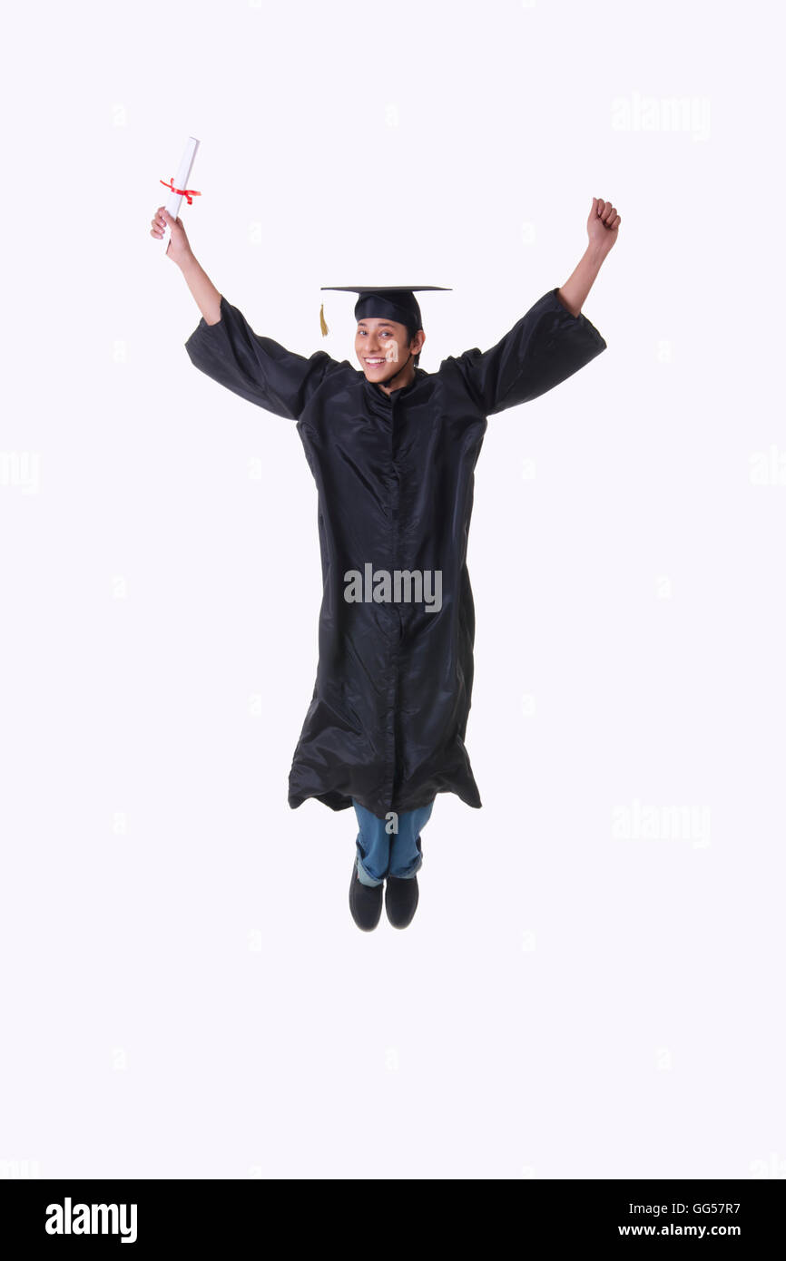 Full length portrait of excited graduate student in mid-air over white ...