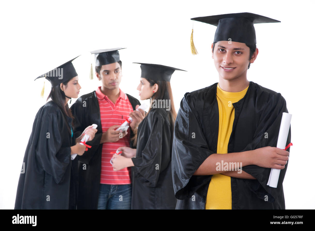 Portrait of confident graduate student with friends discussing against ...