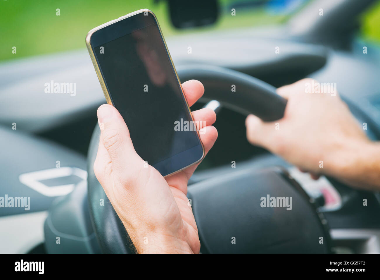 Man using smart phone while driving Stock Photo - Alamy