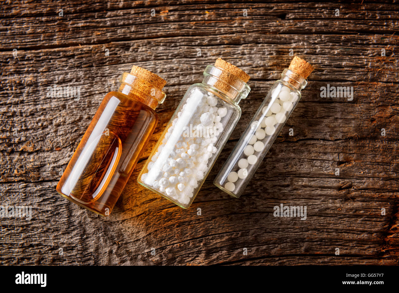 Homeopathic lactose sugar globules and fluid in glass bottles Stock ...