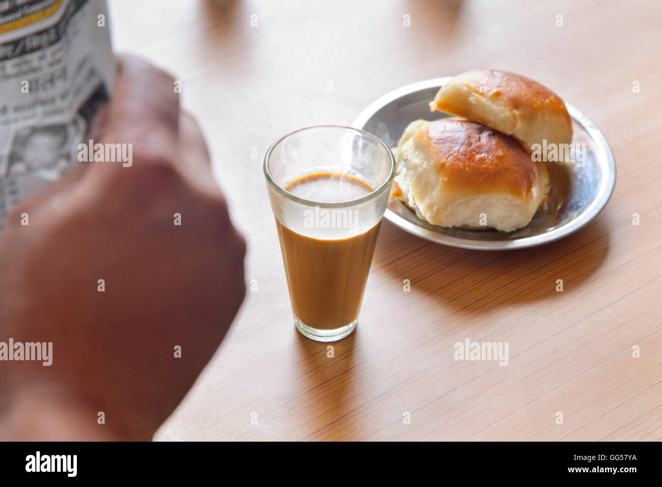 Close-up of hot tea and pav on table Stock Photo - Alamy