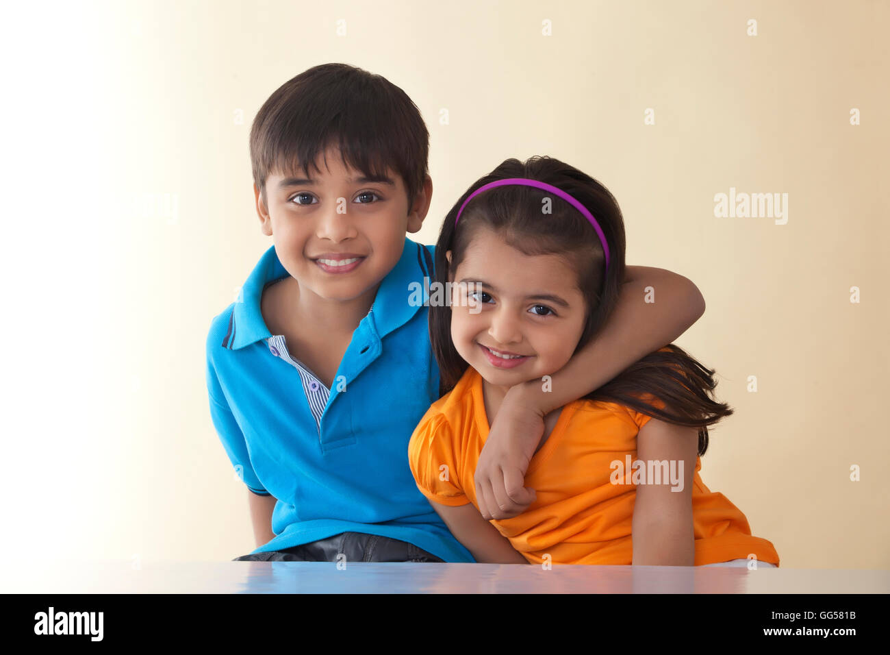 Portrait of loving children against colored background Stock Photo - Alamy