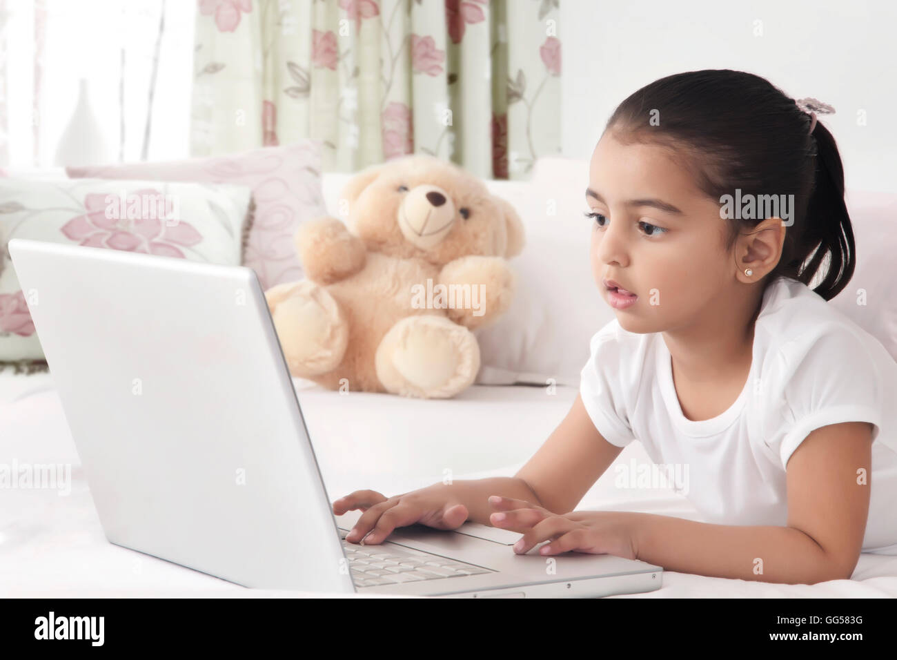 Girl using laptop in bed Stock Photo - Alamy