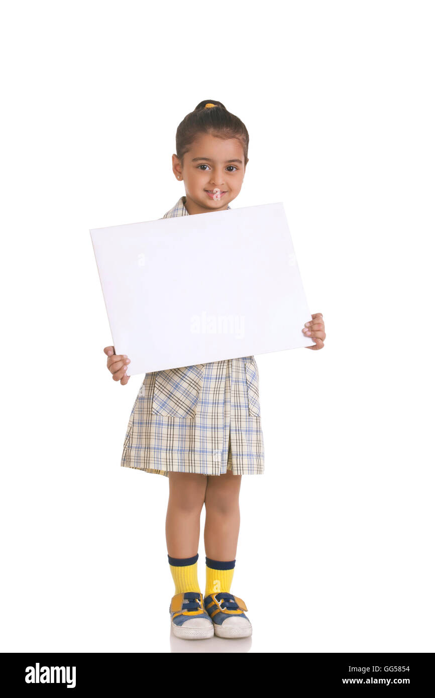 Full length portrait of girl in school uniform holding blank placard ...