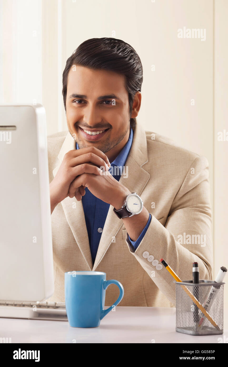 Businessman smiling at computer hi-res stock photography and images - Alamy