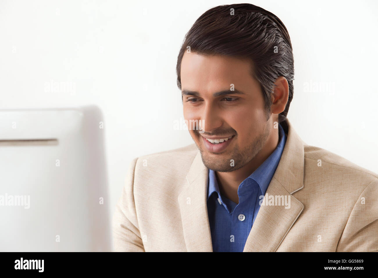 Handsome businessman using computer in office Stock Photo - Alamy