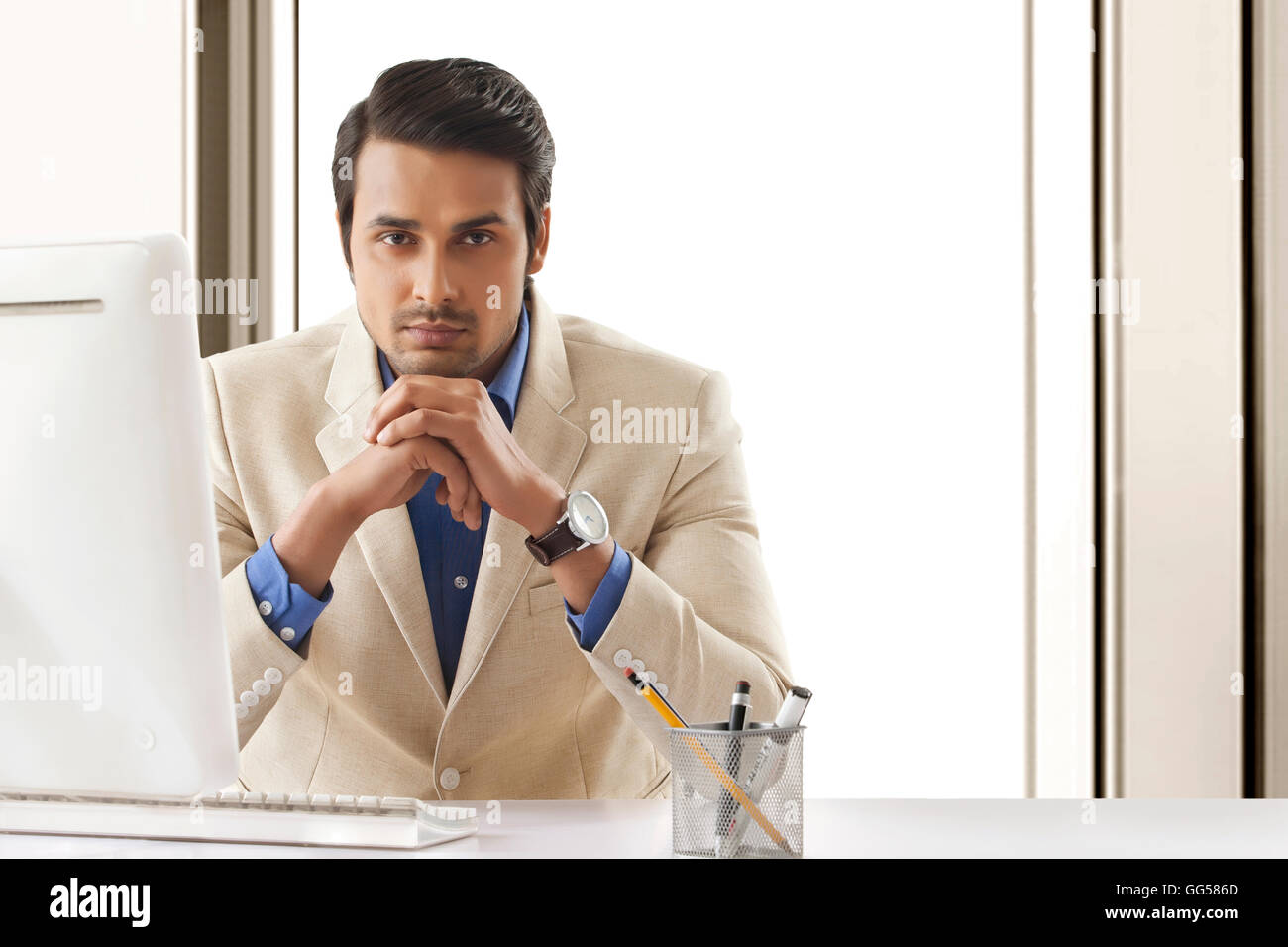 Portrait businessman sitting office desk hi-res stock photography and ...
