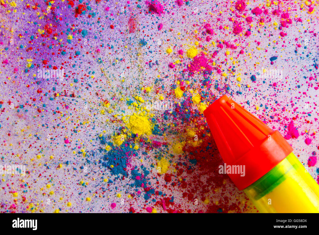 Water gun on colorful powder paint spread over white background Stock ...