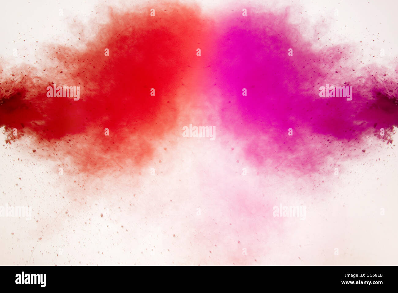 Red and pink Holi colors splashing over white background Stock Photo ...