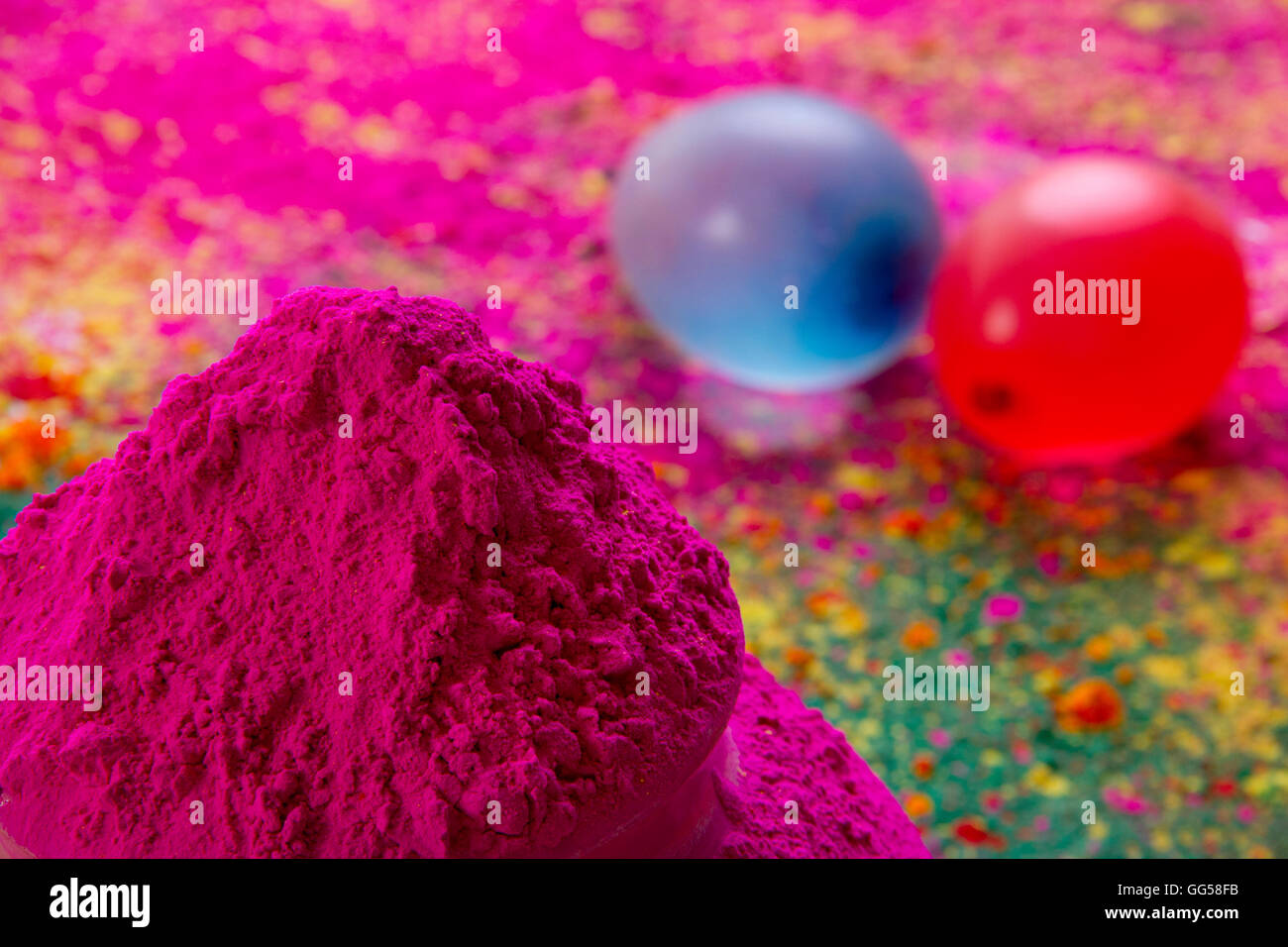 Close-up of pink Holi color powder with water bombs in background Stock ...