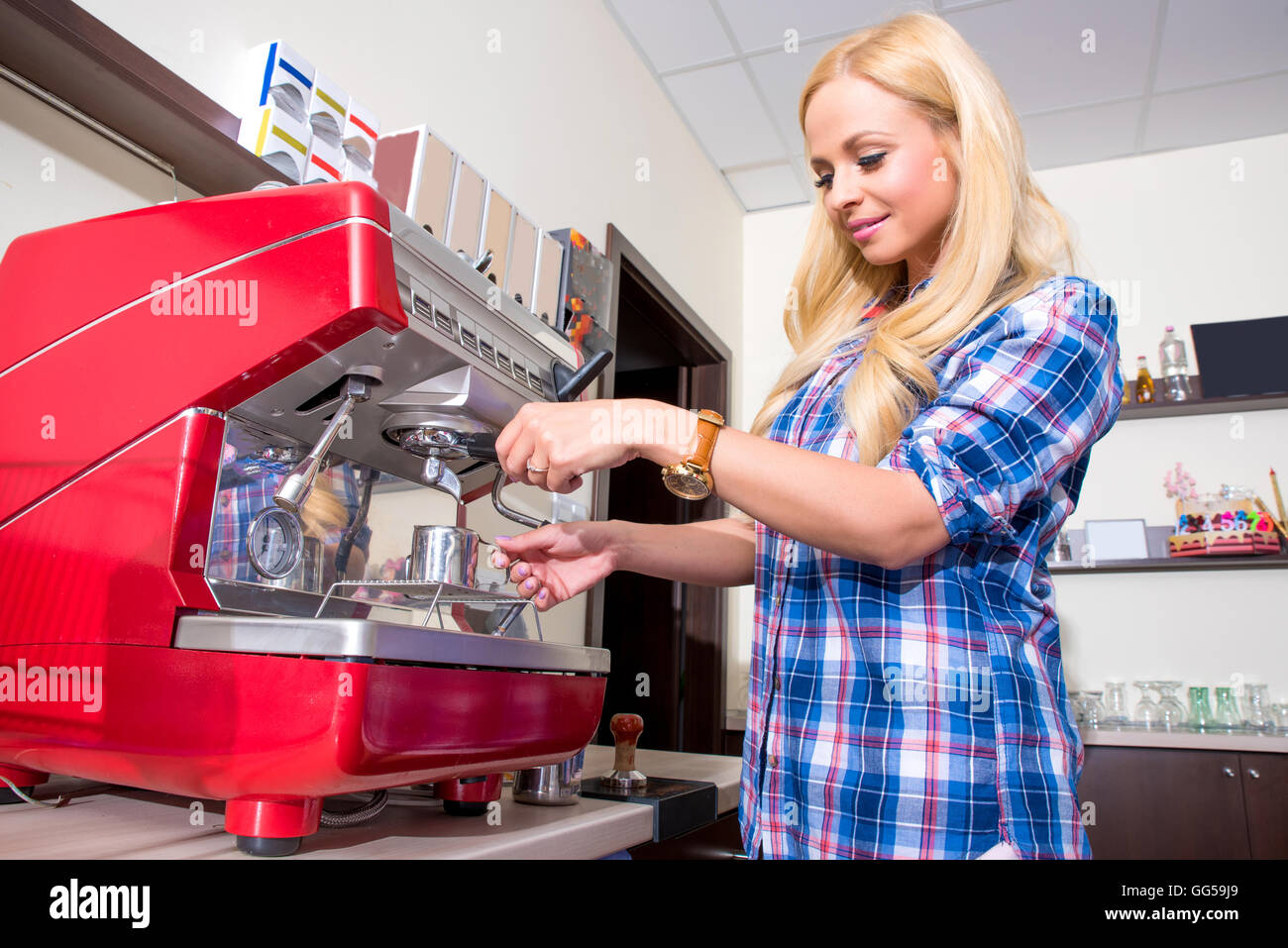 A beautiful young woman making coffee at the bar in a coffee shop Stock ...