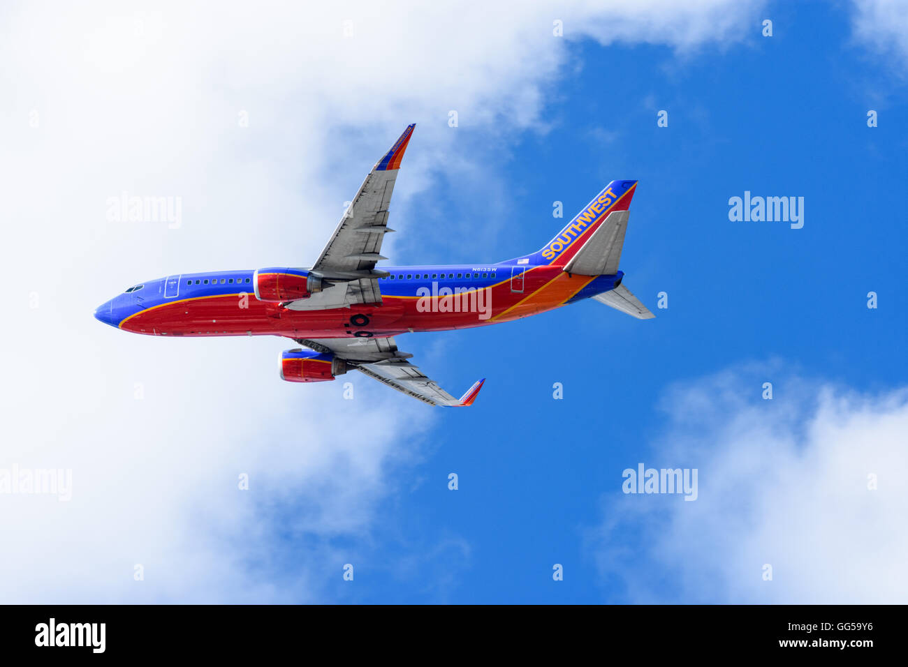 Looking up at a Southwest Airlines Boeing 737-300 plane flying overhead ...