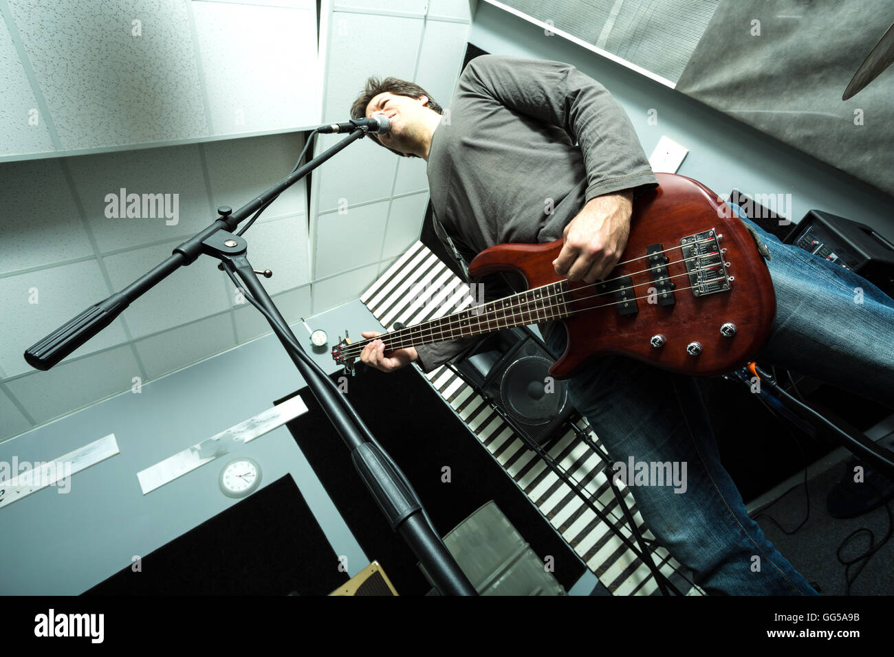 A Rock singer playing bass in the rehearsal Studio Stock Photo - Alamy
