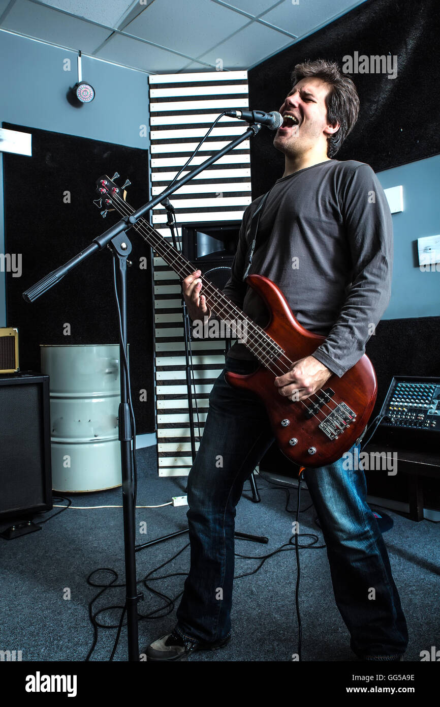 Black and white Portrait of a Rock singer playing bass in the rehearsal ...