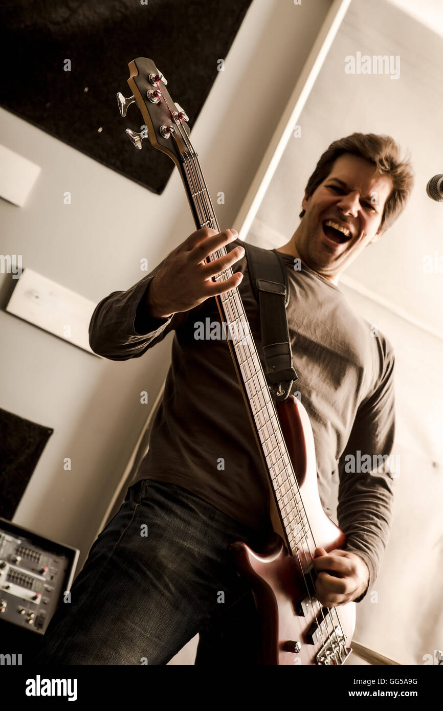Black and white Portrait of a Rock singer playing bass in the rehearsal ...