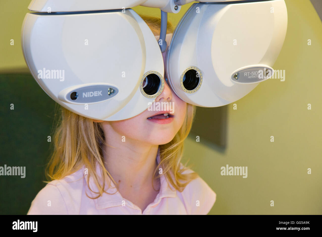 Five or six year / 5 or 6 years old girl undertaking / taking / having ...